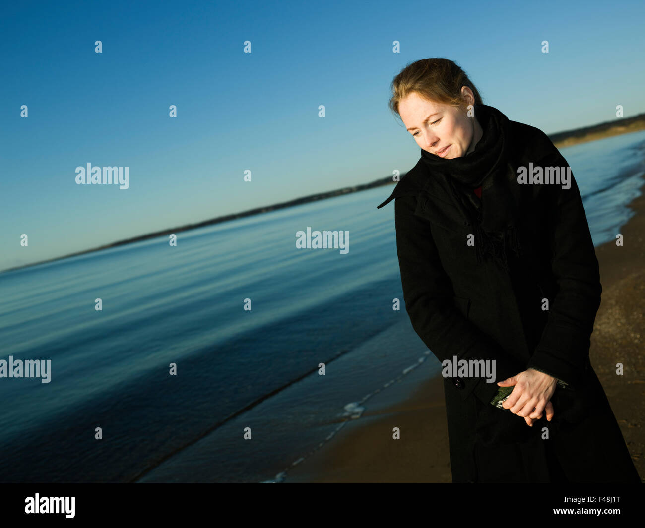 Woman on a beach in the evening, Sweden Stock Photo - Alamy