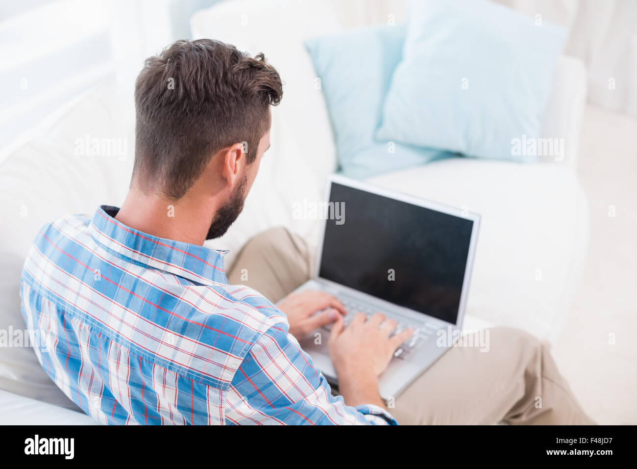 Back turned man typing on laptop Stock Photo - Alamy