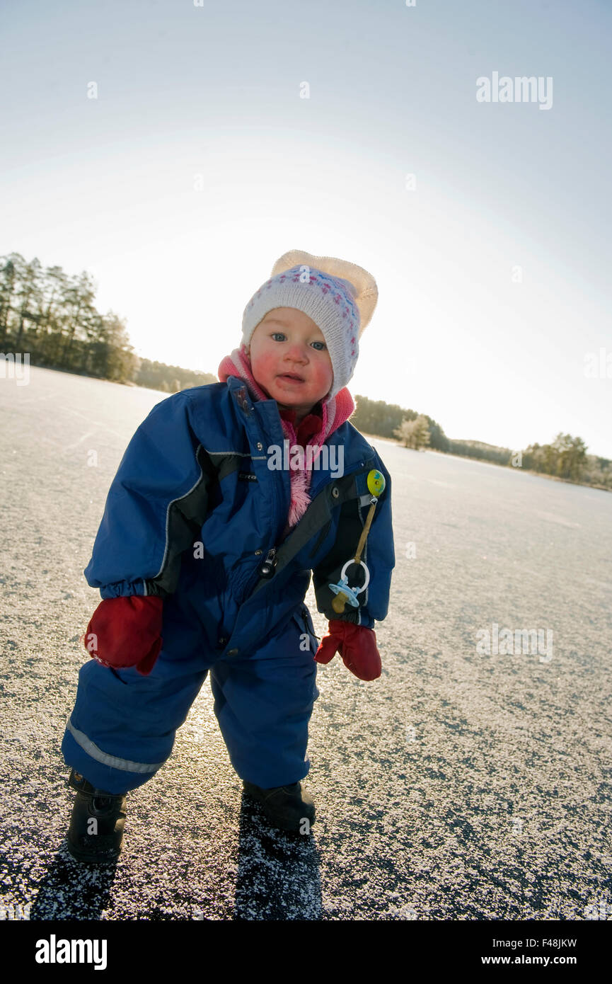 Portrait of a baby girl standing on the ice, Sweden Stock Photo - Alamy