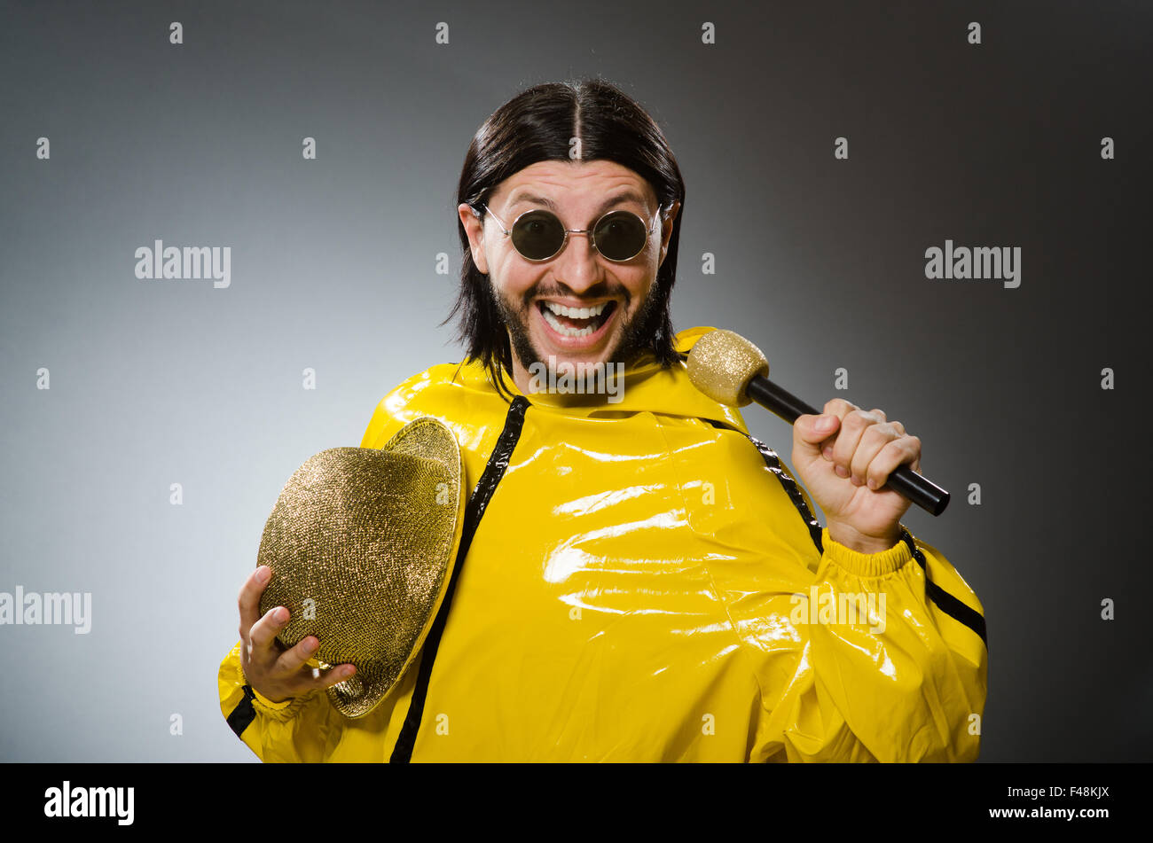 Man wearing yellow suit with mic Stock Photo - Alamy