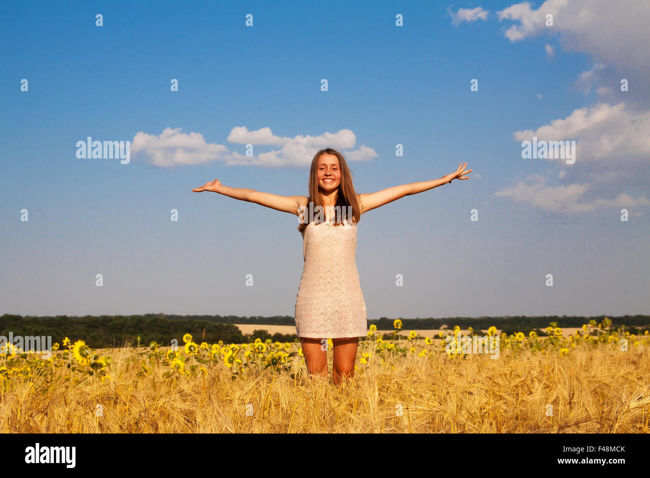 Happy young girl in field Stock Photo - Alamy