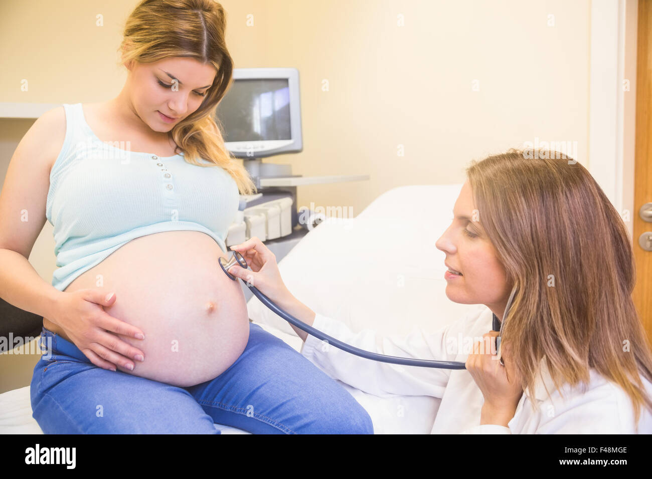 Pregnant woman getting a check up Stock Photo - Alamy