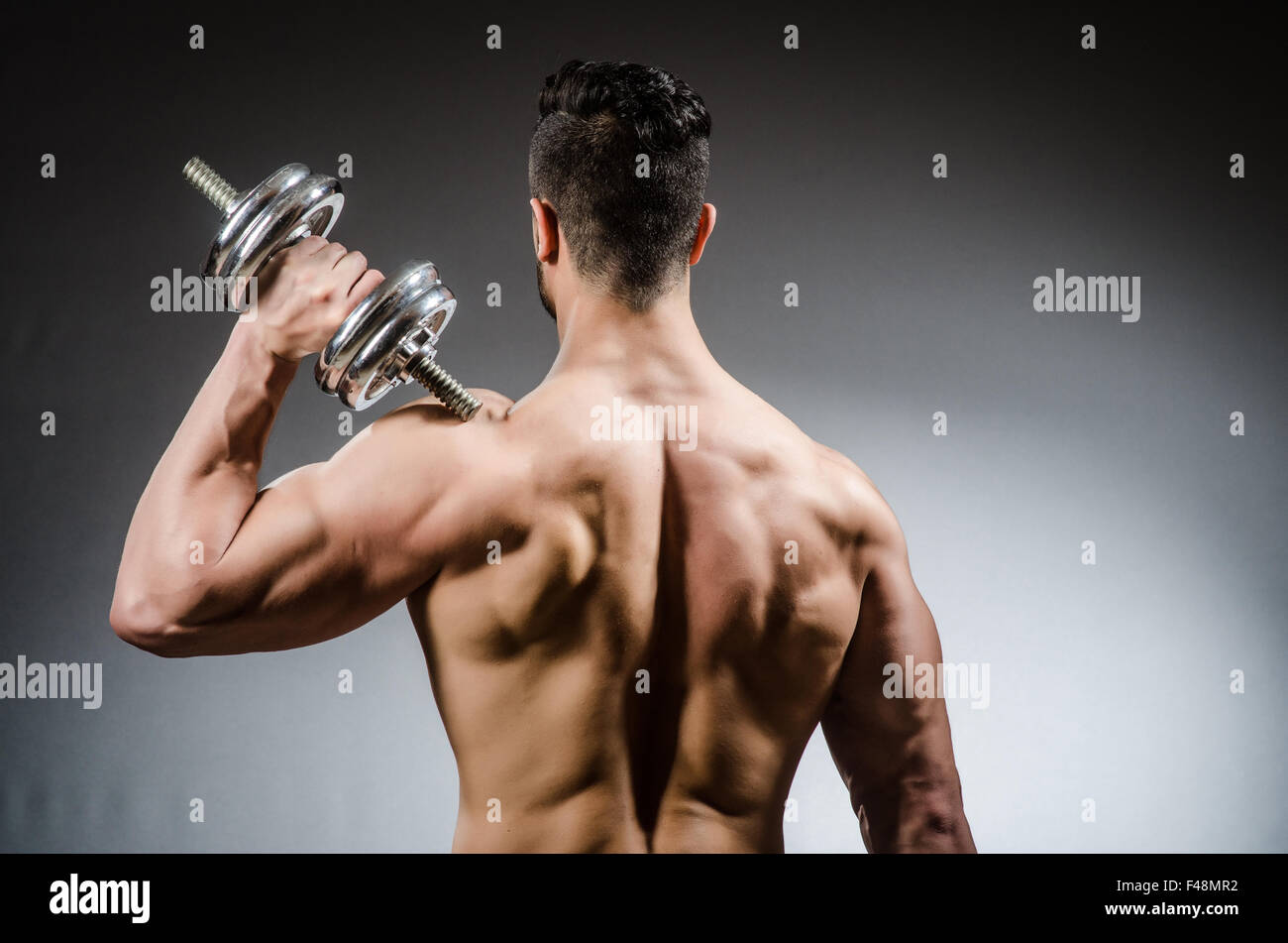 Muscular ripped bodybuilder with dumbbells Stock Photo - Alamy