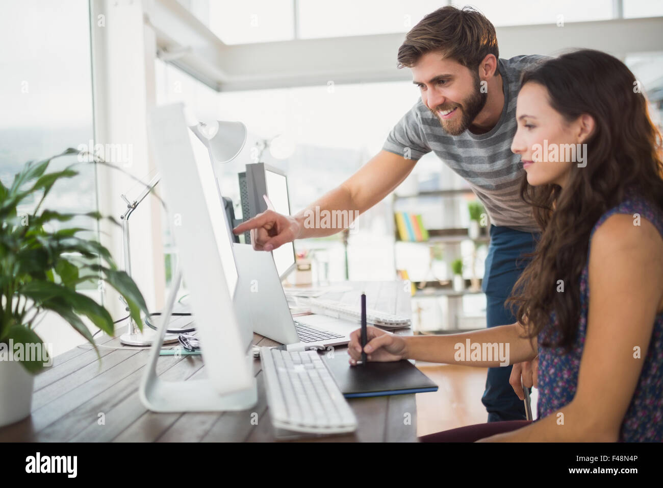 Smiling casual business team working together Stock Photo - Alamy Smiling casual business team working together Stock Photo - Alamy