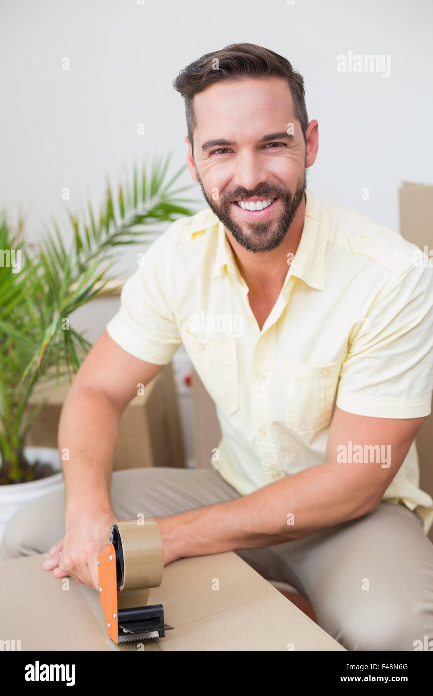 Happy handsome man packing box Stock Photo - Alamy
