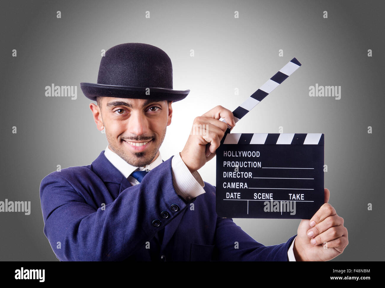 Man with movie clapper against the gradient Stock Photo - Alamy