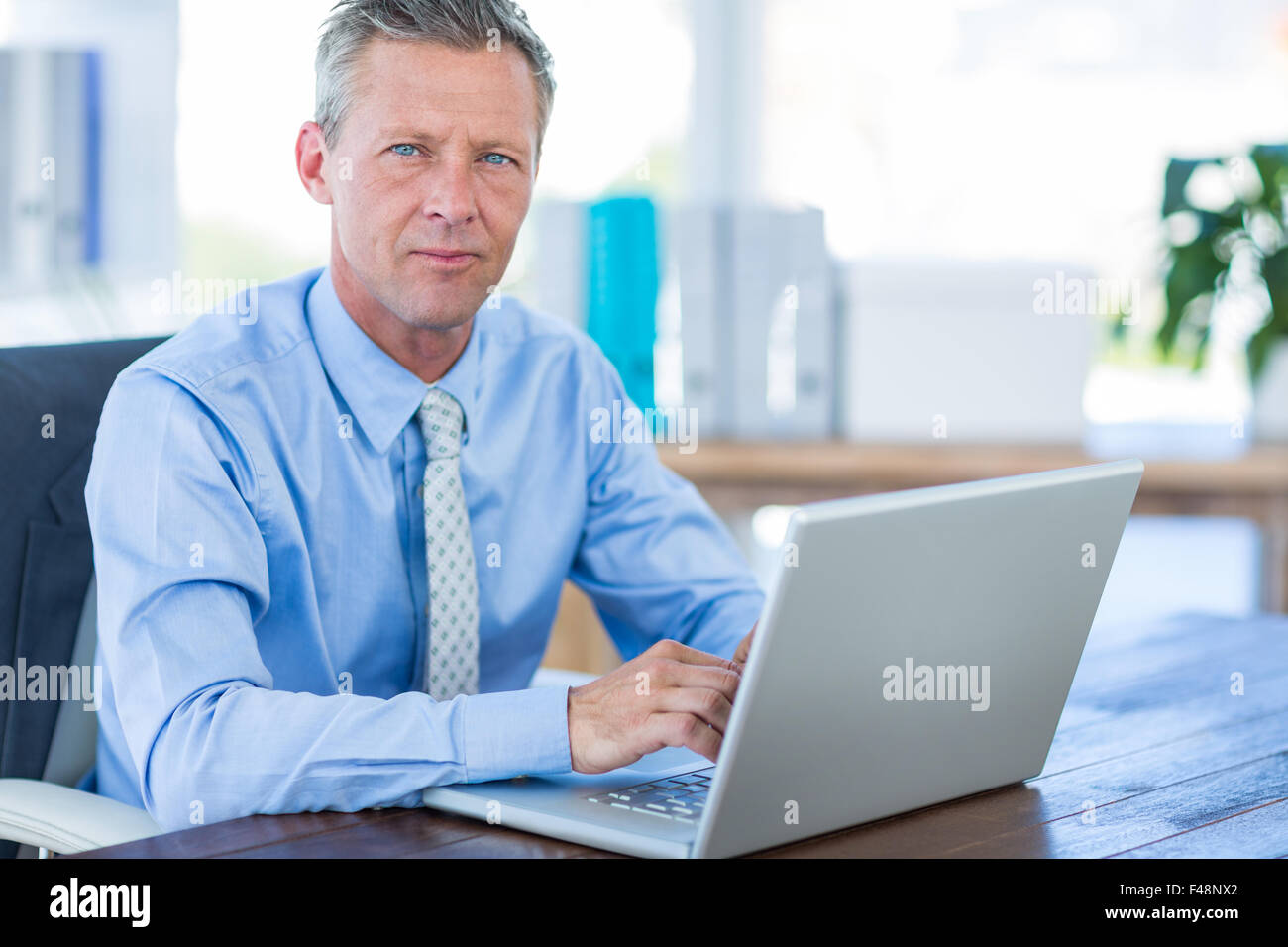 Thoughtful businessman using laptop computer Stock Photo - Alamy