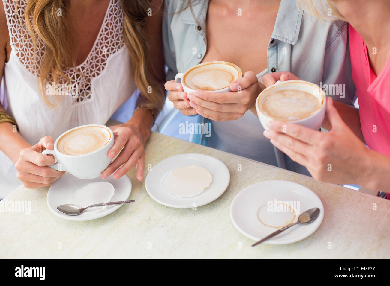 Happy friends having coffee together Stock Photo - Alamy