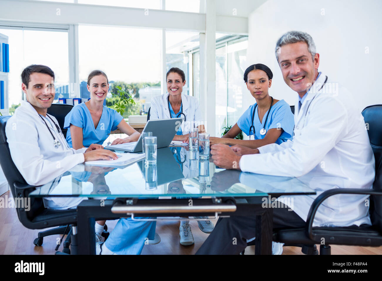 Team of smiling doctors having a meeting Stock Photo - Alamy