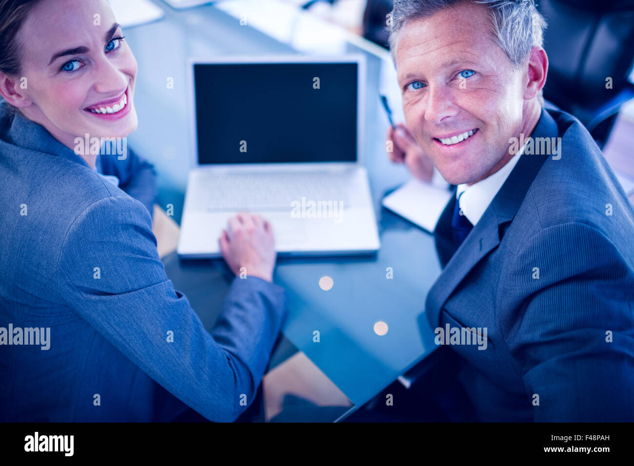 Happy business people looking at camera Stock Photo - Alamy