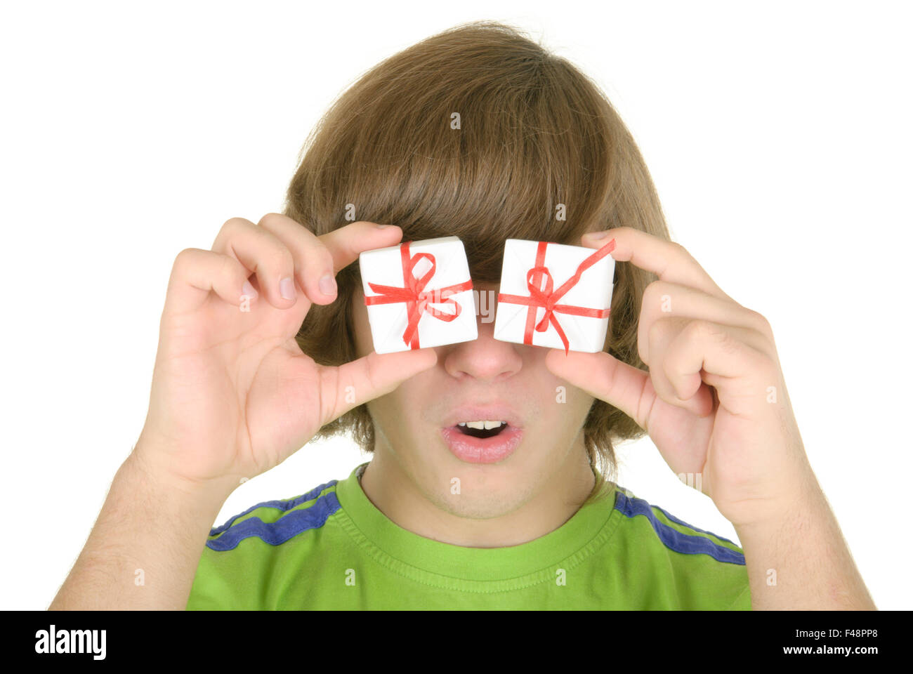 Teenager holds gifts before eyes Stock Photo - Alamy