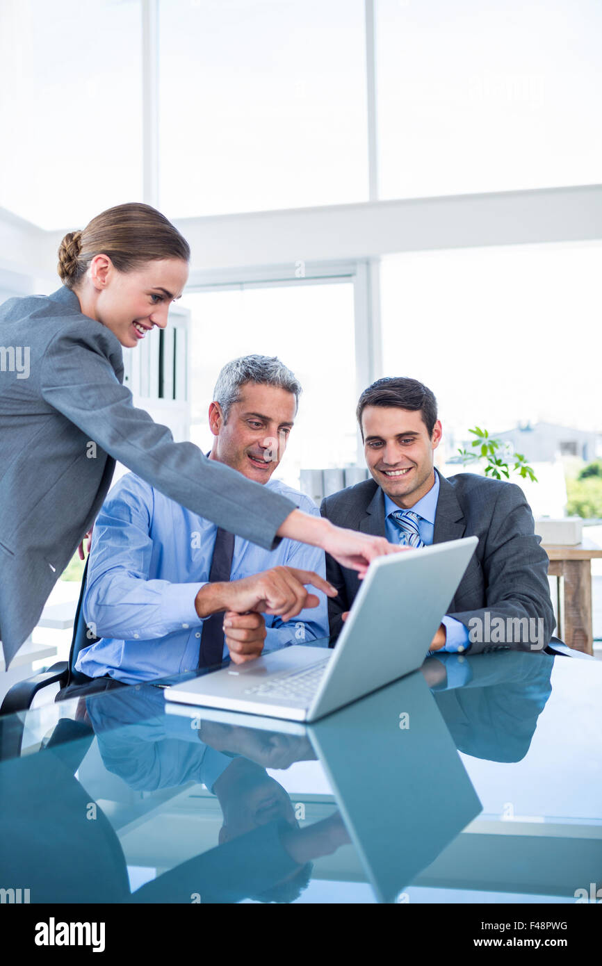 Business people looking at laptop computer Stock Photo - Alamy