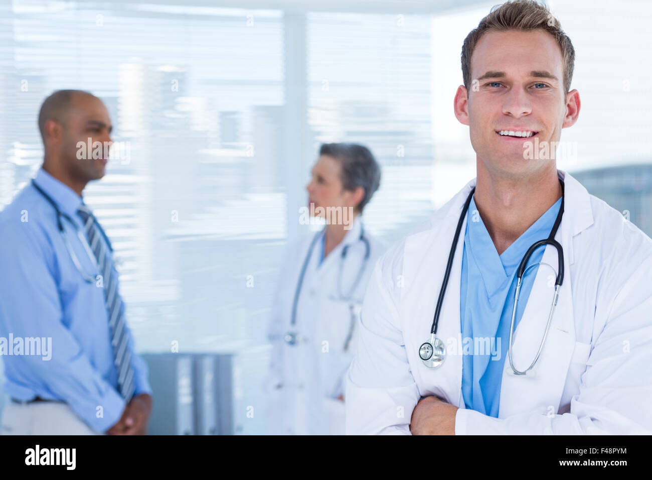 Smiling doctor looking at the camera Stock Photo - Alamy