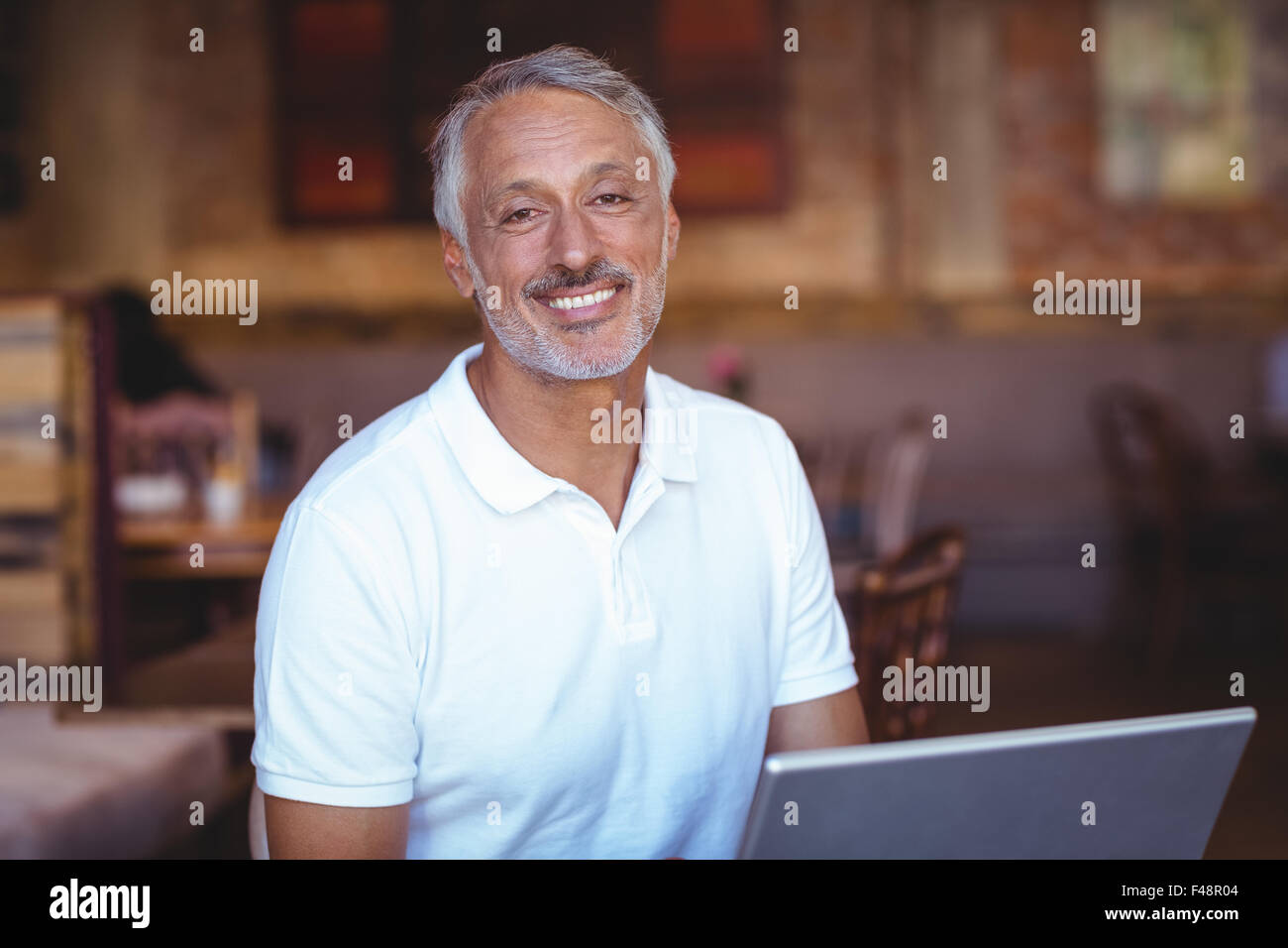 Happy man using his laptop computer Stock Photo - Alamy