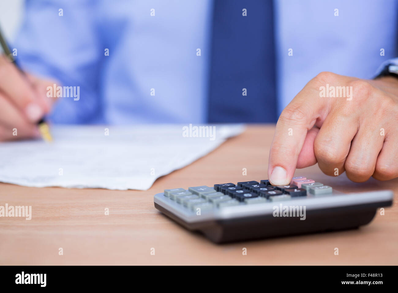 Close up hands using the calculator Stock Photo - Alamy