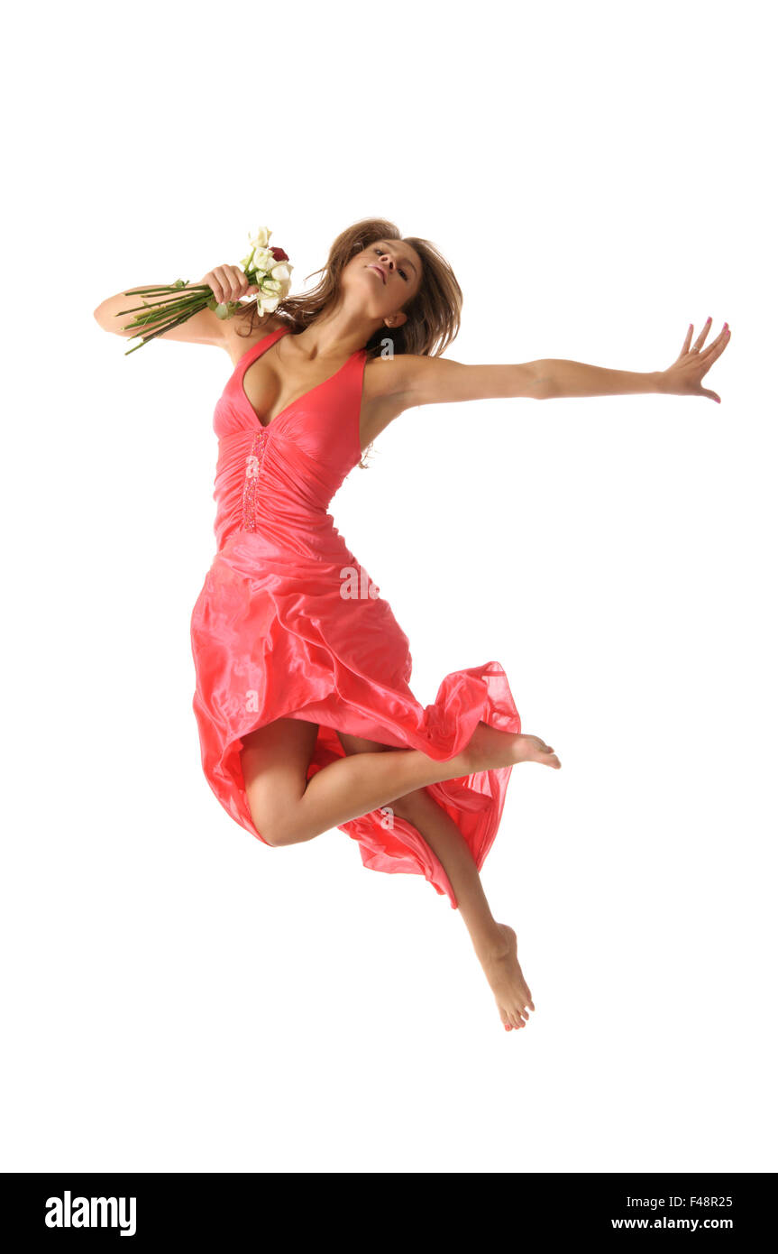 Beautiful young woman jumps with flower Stock Photo - Alamy