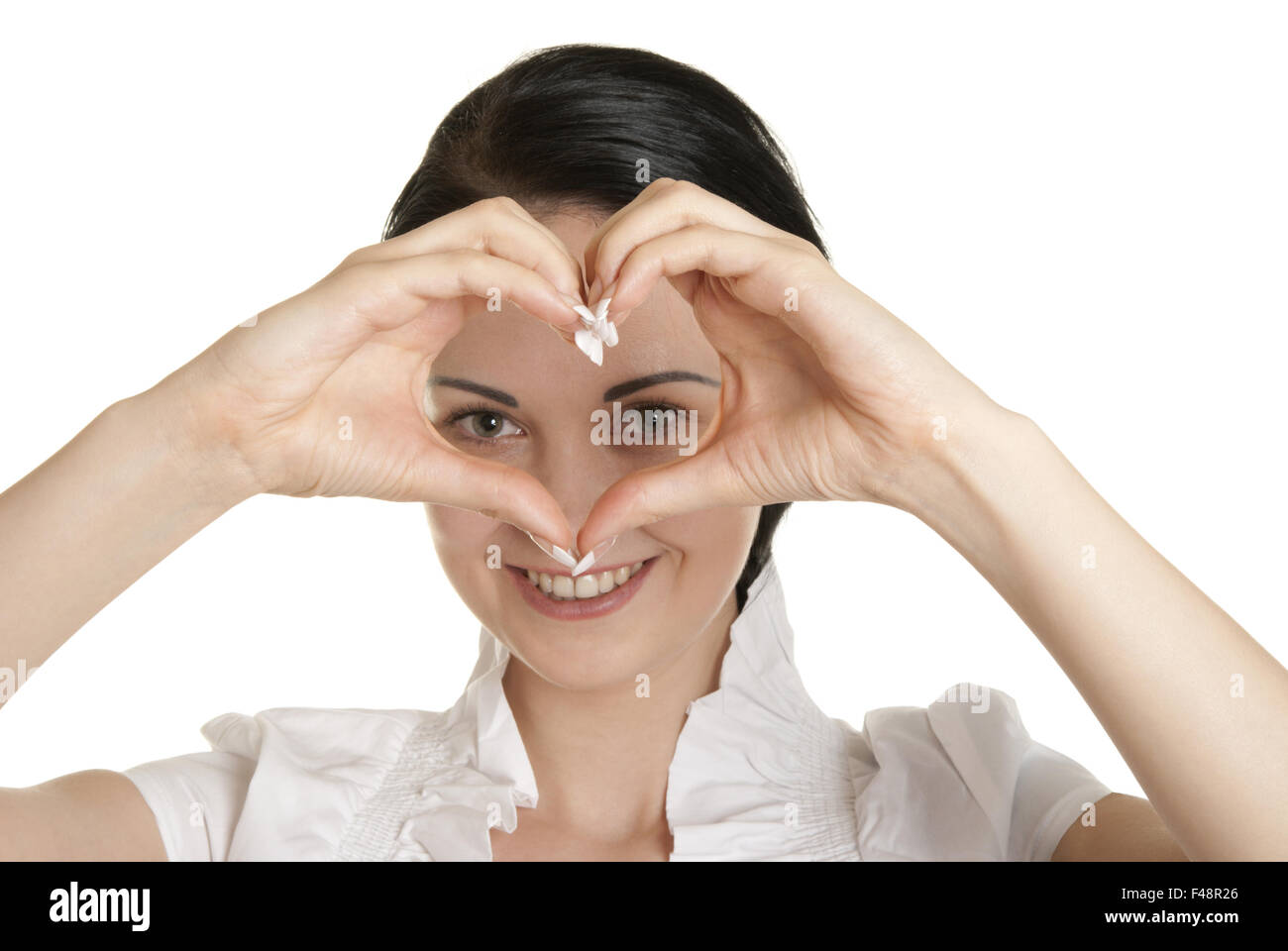 Young woman shows fingers heart symbol Stock Photo - Alamy