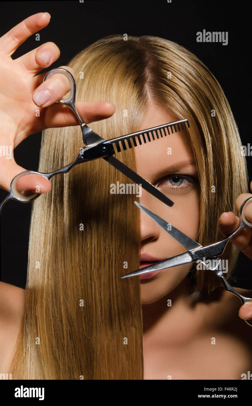 Young woman with straight hair and scissors Stock Photo - Alamy