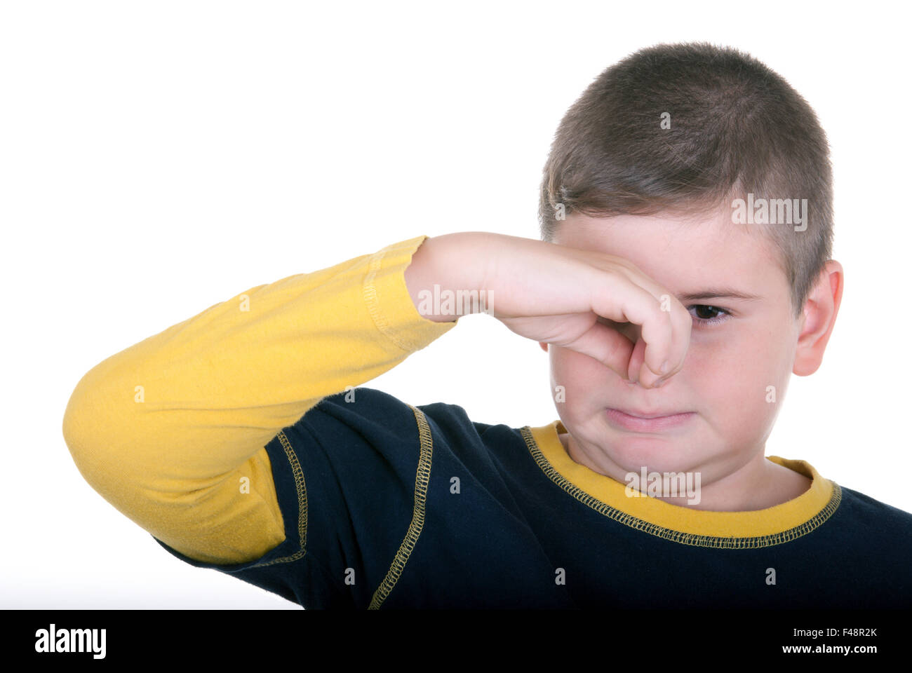 Boy holds nose Stock Photo - Alamy