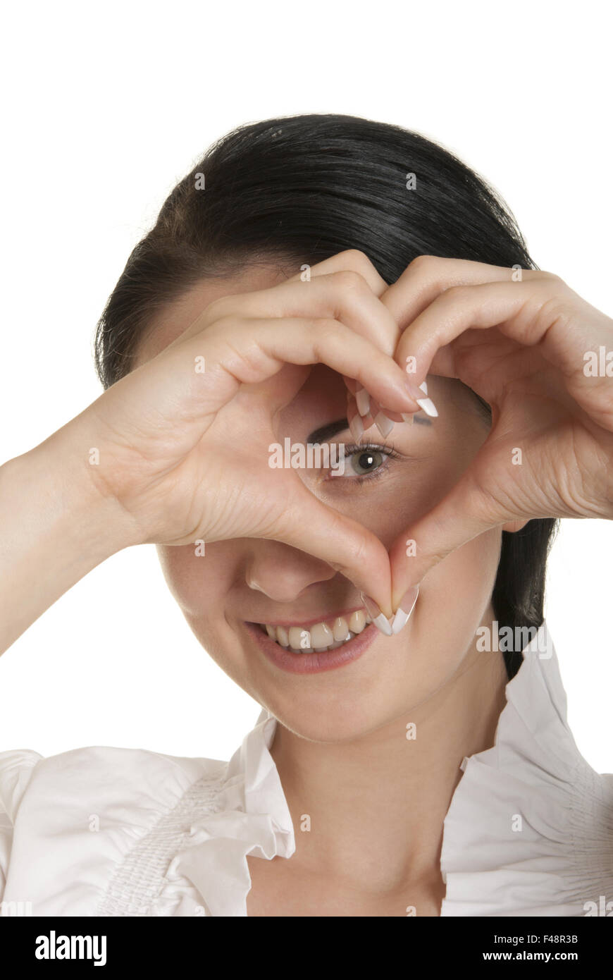 Young woman shows fingers heart symbol Stock Photo - Alamy