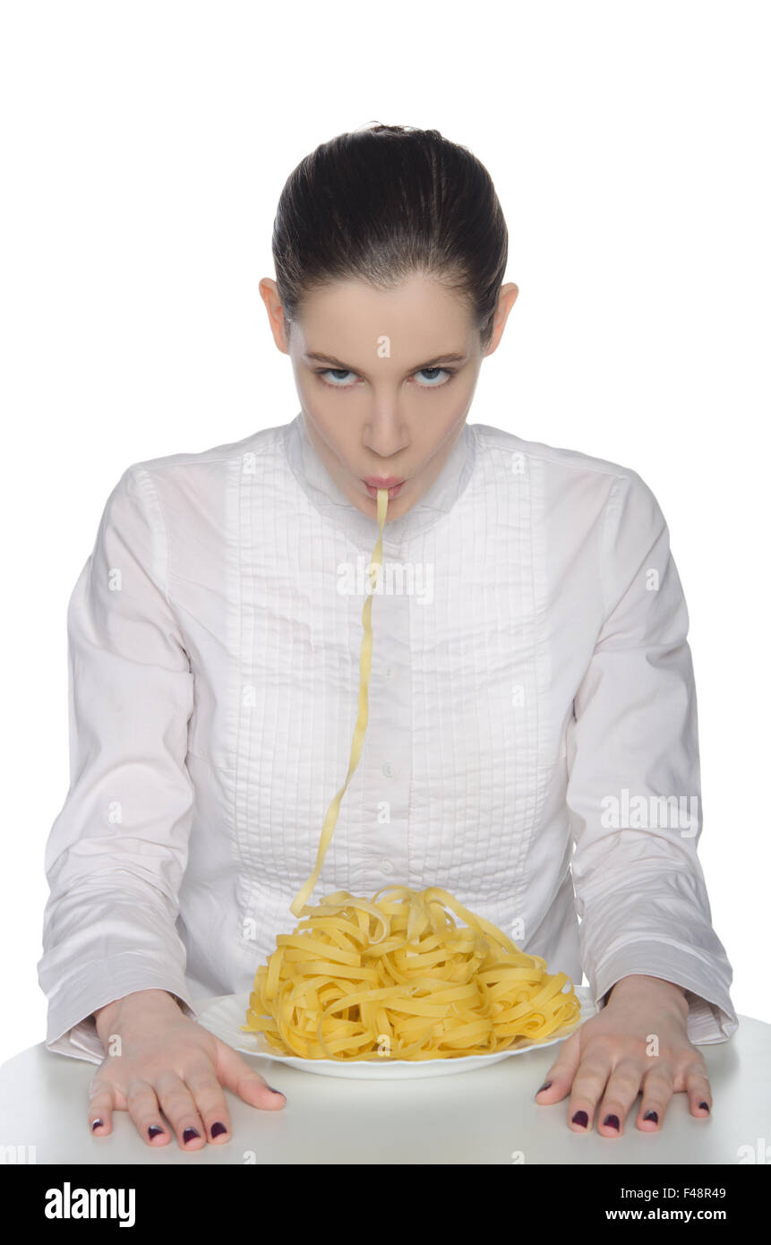 Young woman in with eating pasta dish Stock Photo - Alamy
