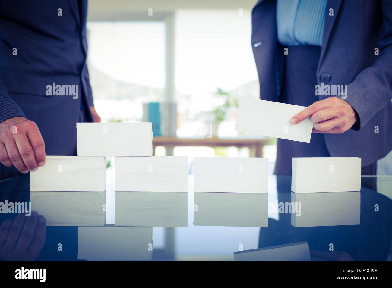 Business people stacking paper bloc Stock Photo - Alamy