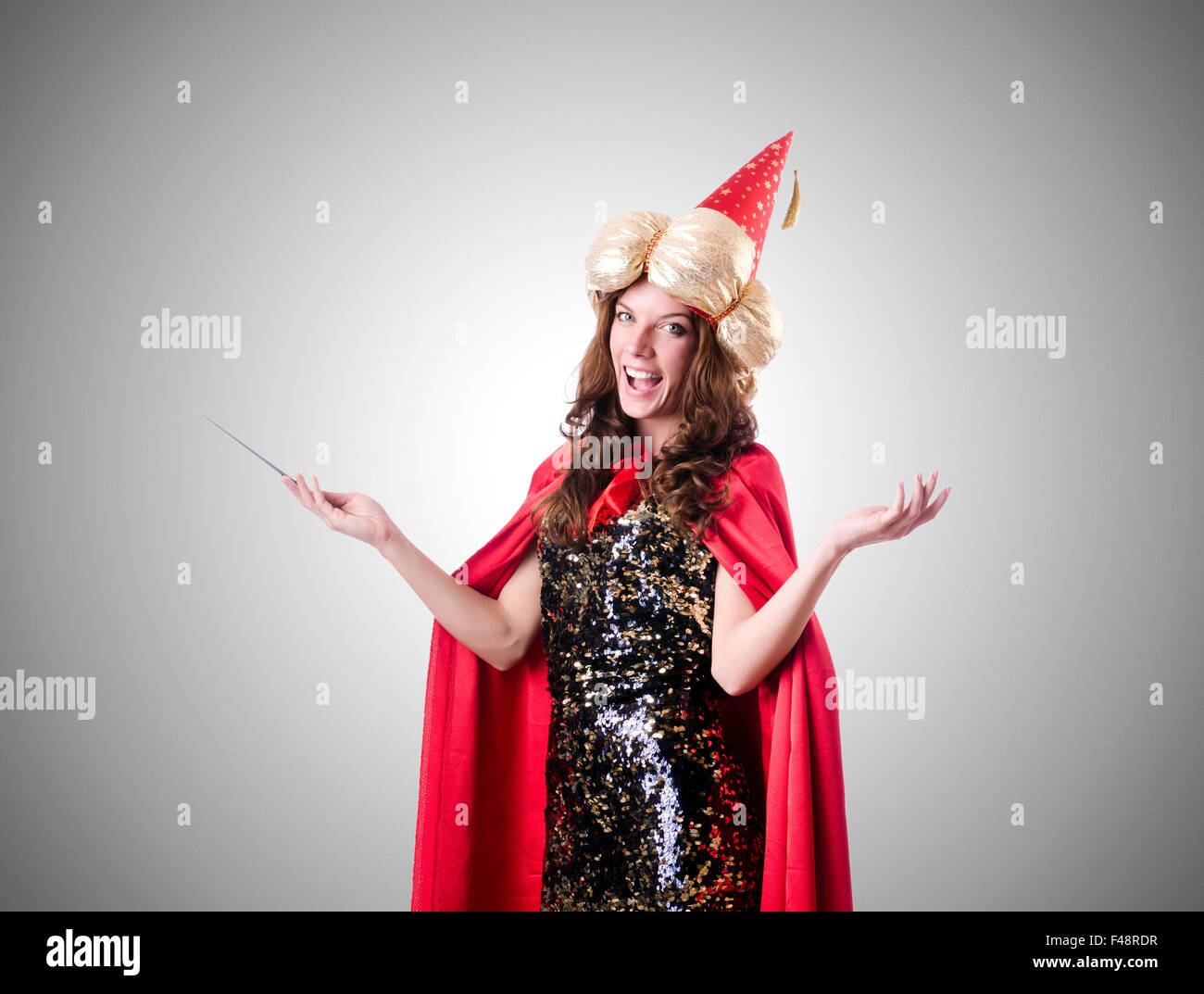 Female magician against the gradient Stock Photo - Alamy