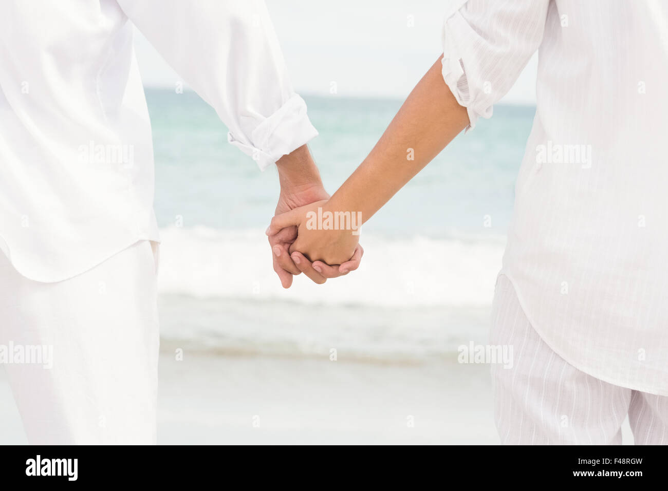 Couple walking hand in hand Stock Photo - Alamy