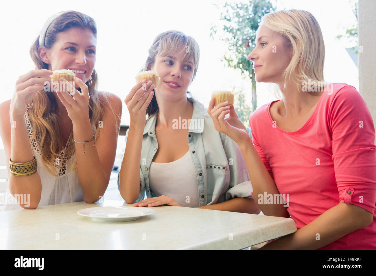 Happy friends having cakes together Stock Photo - Alamy