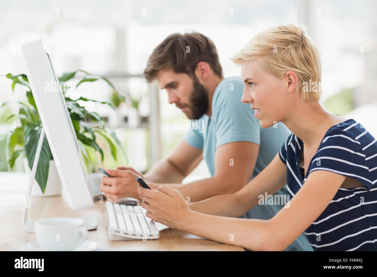 Creative business people working together on computer Stock Photo - Alamy