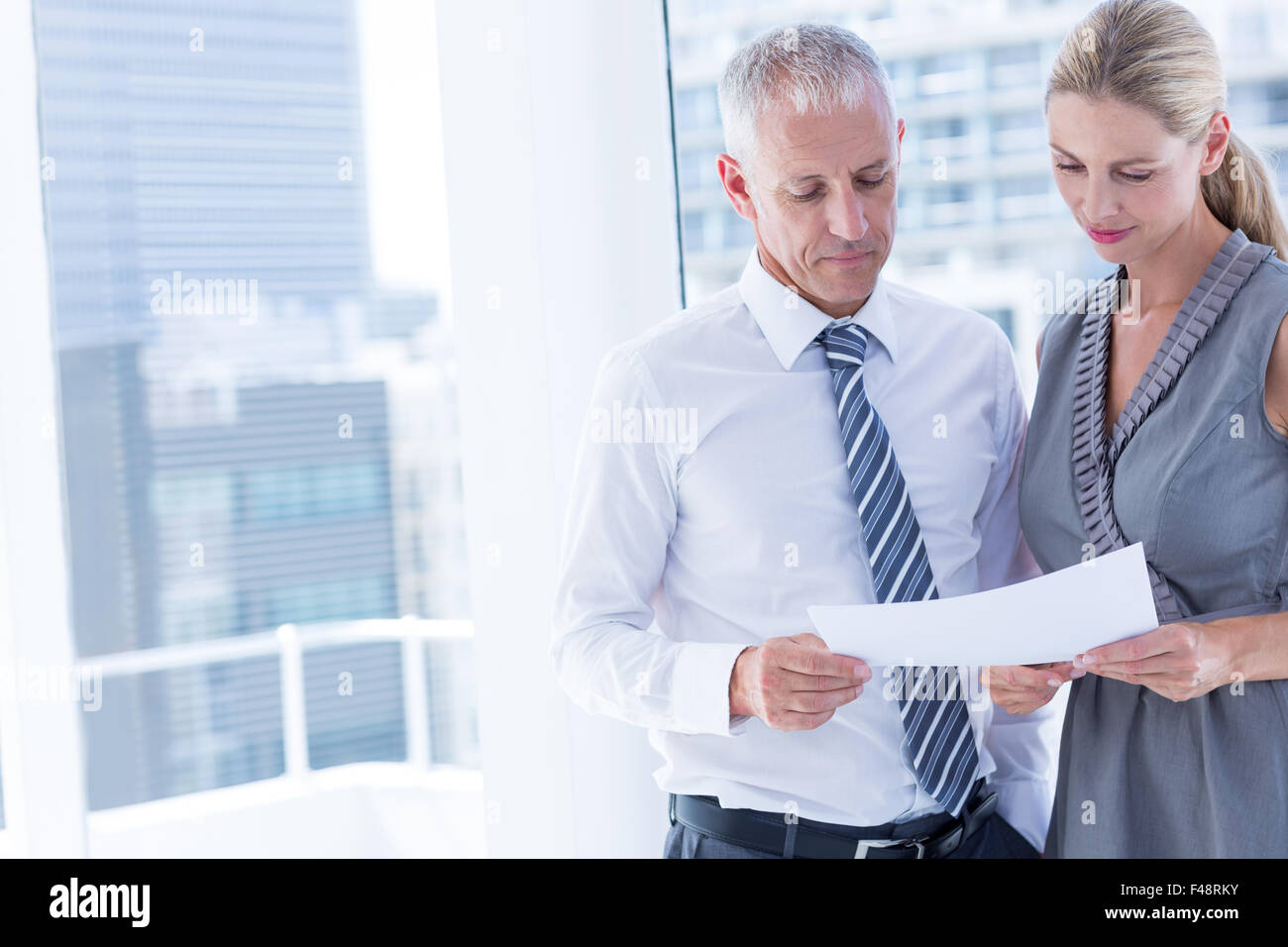 Business people talking over a paper sheet Stock Photo - Alamy