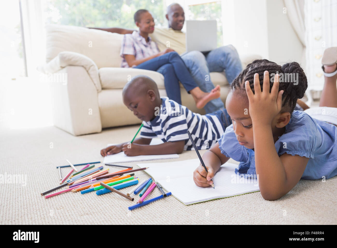Happy siblings on the floor drawing Stock Photo - Alamy