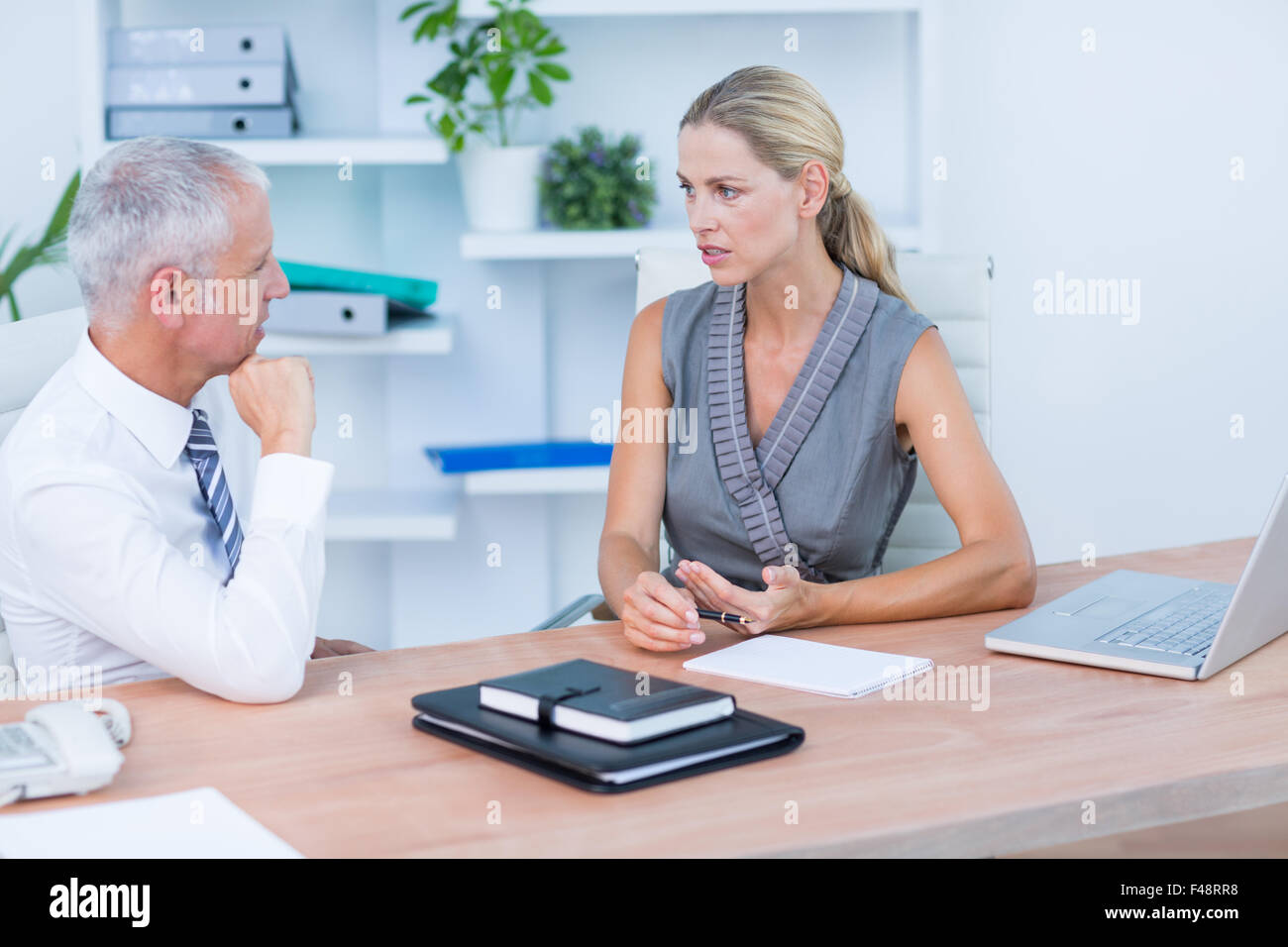 Colleagues speaking and working Stock Photo - Alamy