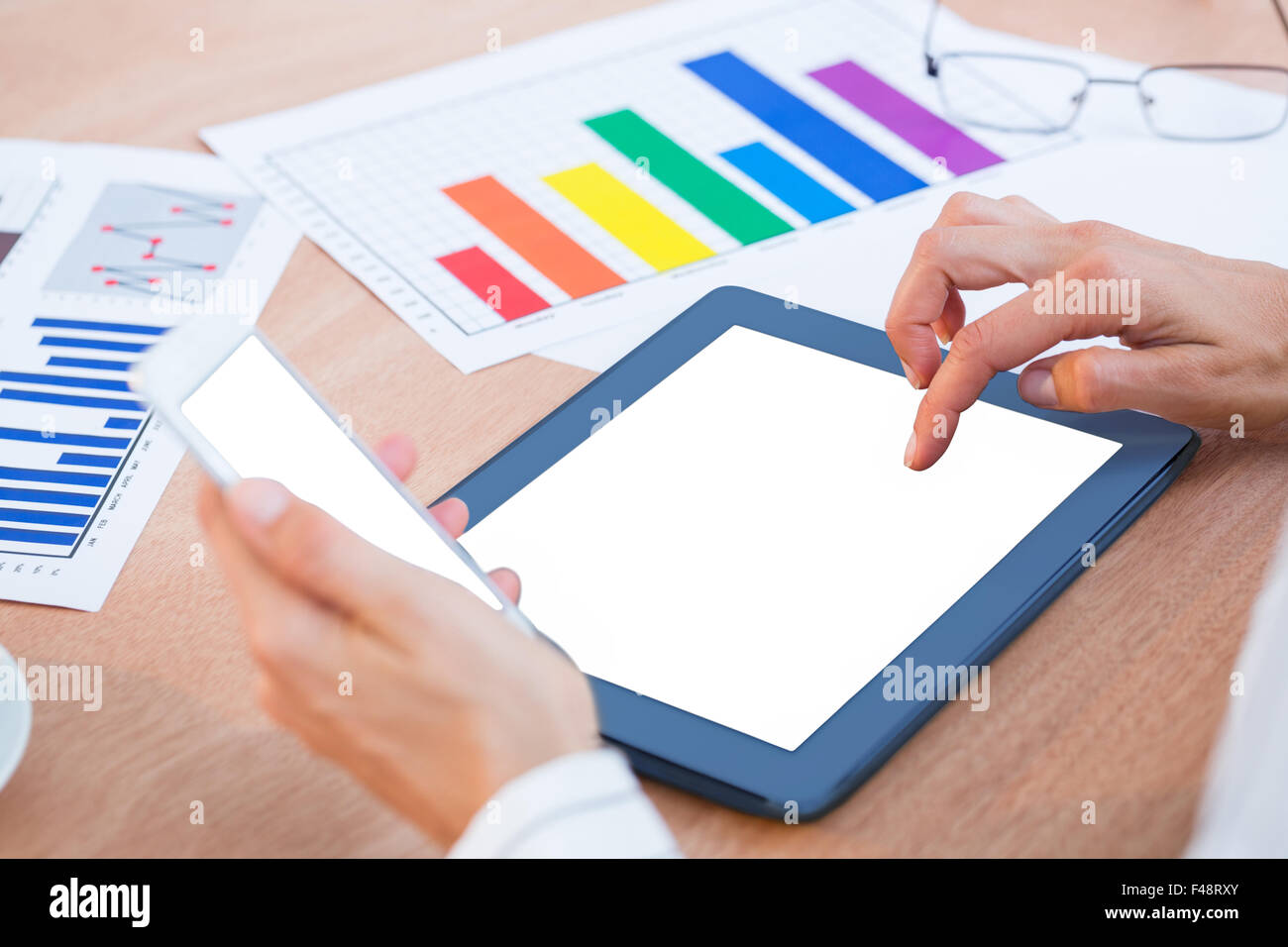 Businesswoman using two digital tablet Stock Photo - Alamy