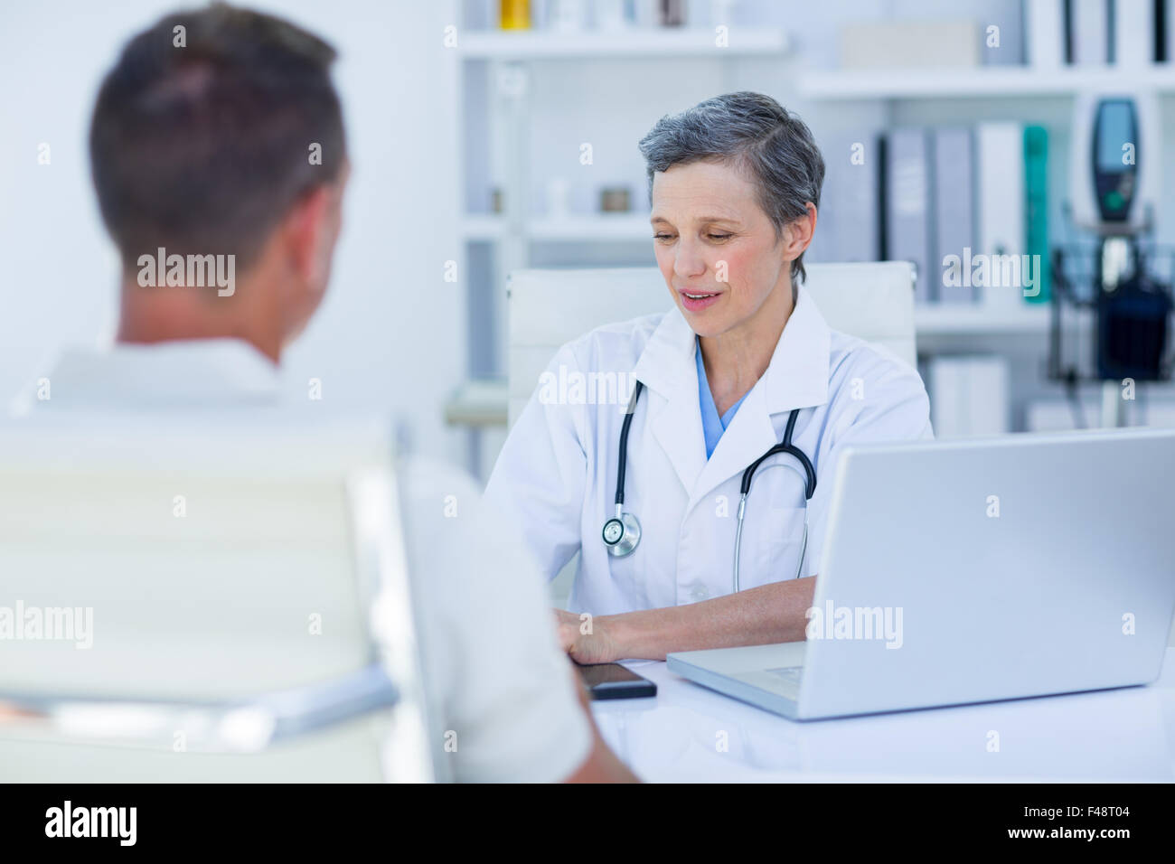 Female doctor speaking with her patient Stock Photo - Alamy
