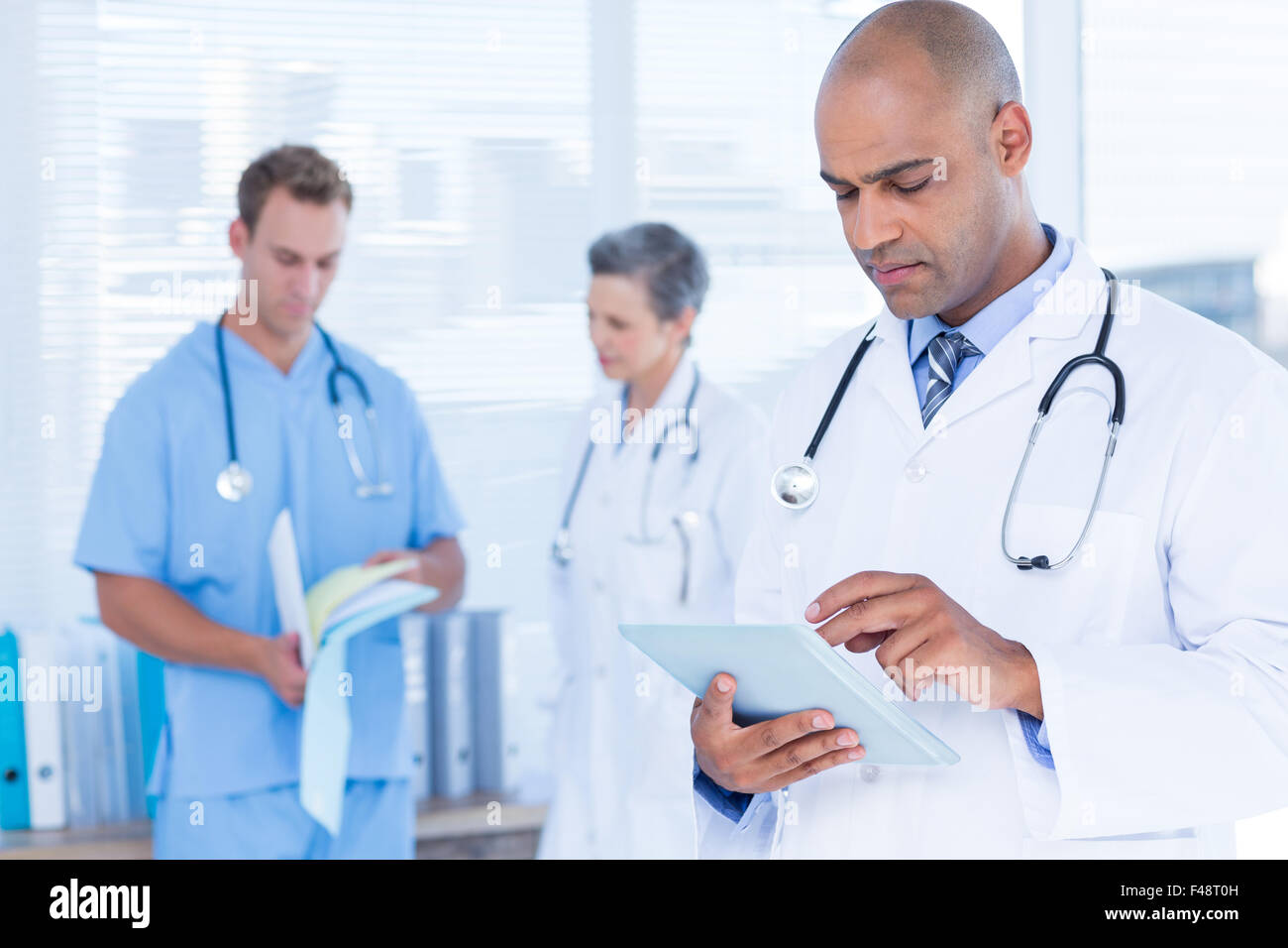 Serious doctor using touchscreen hi-res stock photography and images ...