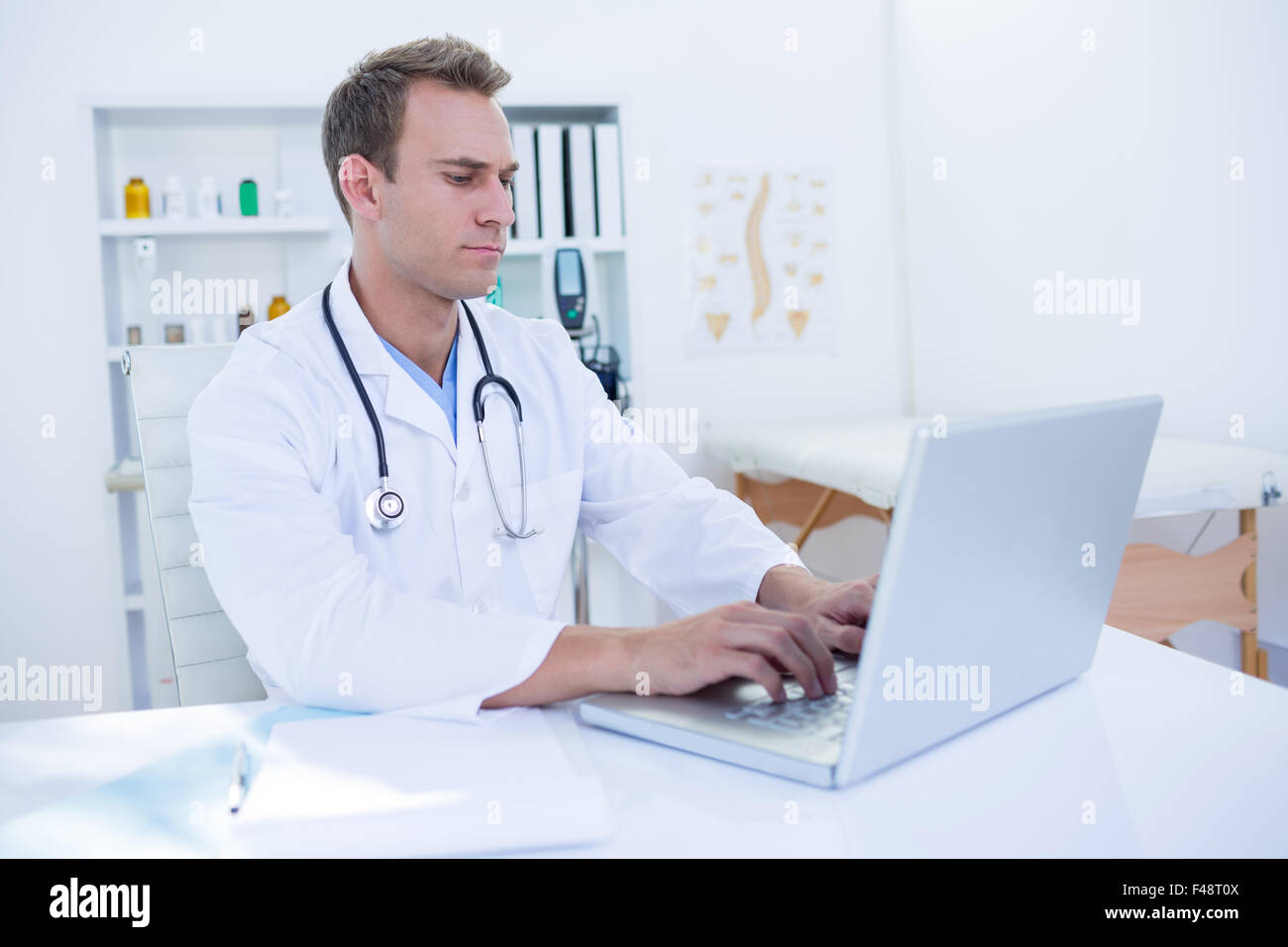 Focused doctor working with laptop Stock Photo - Alamy