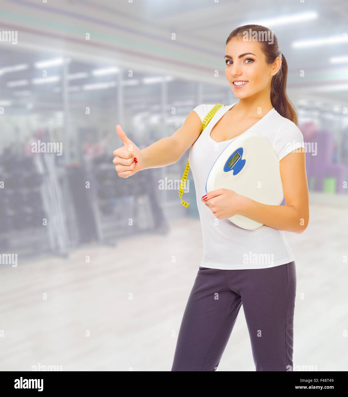 Sporty young girl at fitness club Stock Photo - Alamy