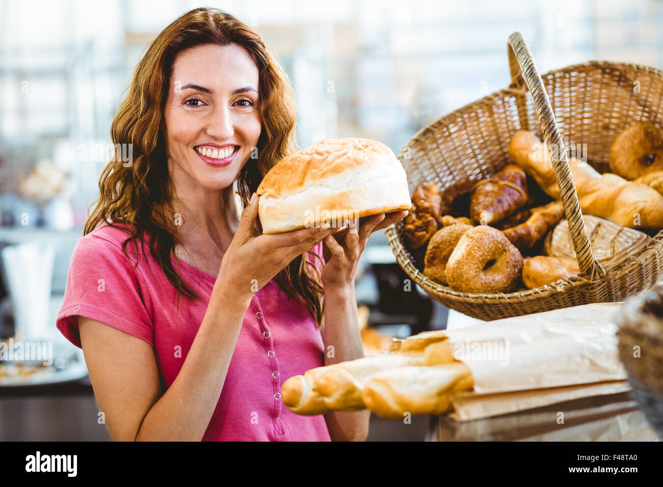 Pretty brunette showing loaf of bread Stock Photo - Alamy