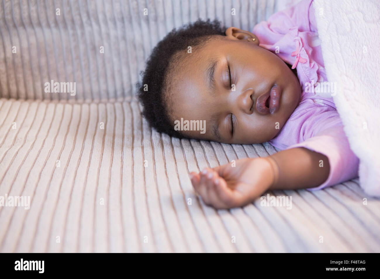 Little girl sleeping on the sofa Stock Photo - Alamy