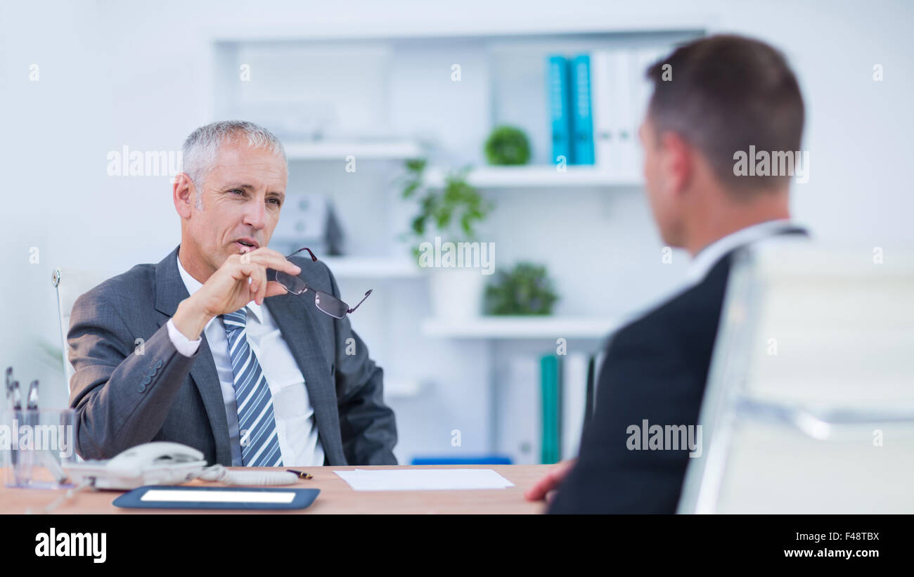 Two serious businessmen speaking and working Stock Photo - Alamy