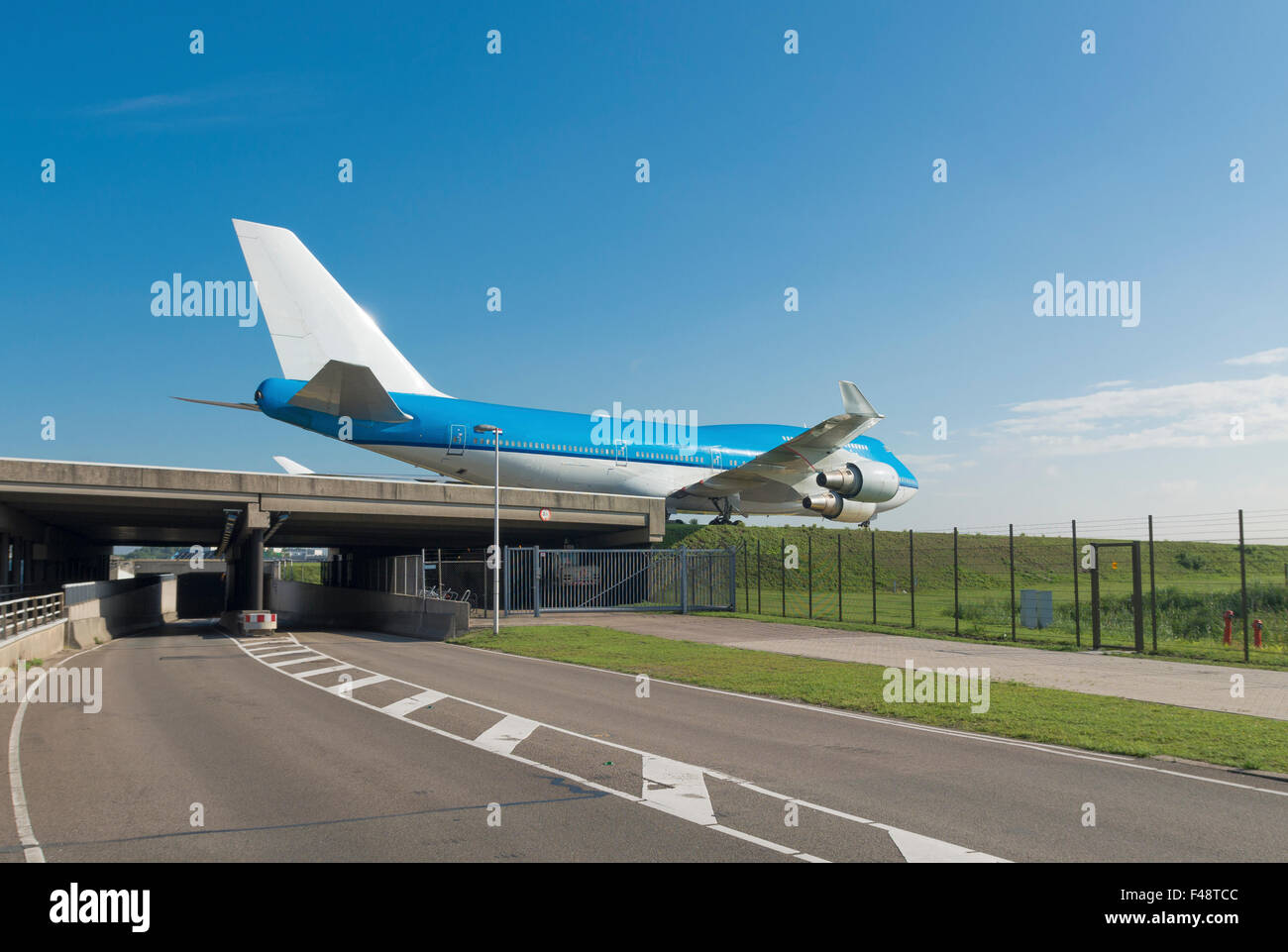 passenger airplane over a highway taxiing to the runway Stock Photo - Alamy