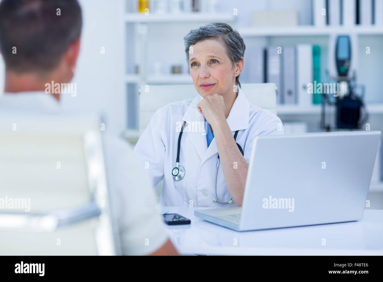 Female doctor speaking with her patient Stock Photo - Alamy