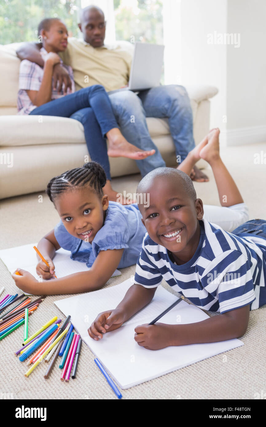 Happy siblings on the floor drawing Stock Photo - Alamy