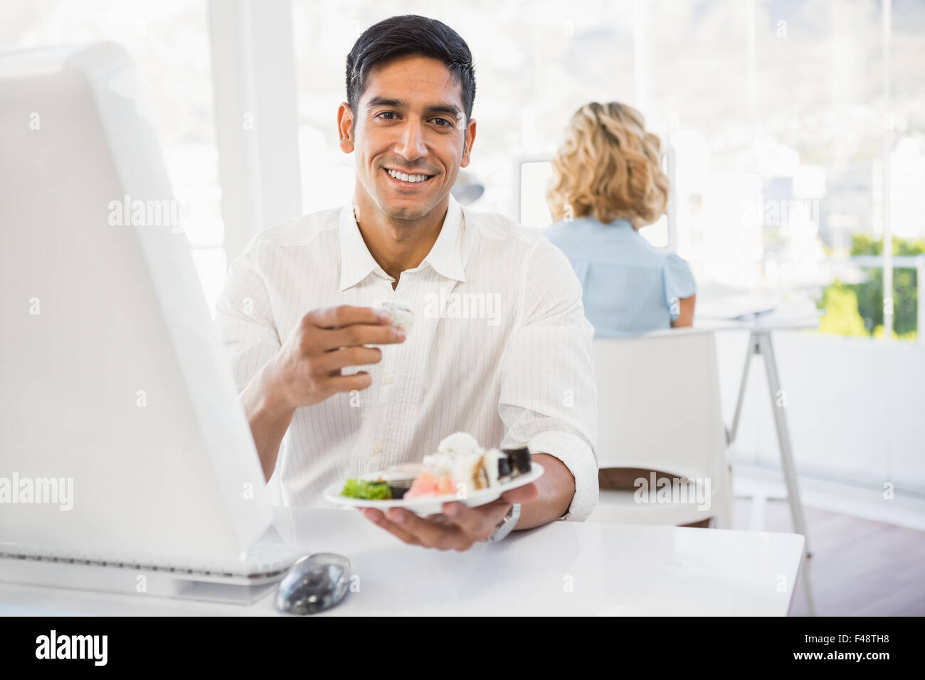 Young smiling business people eating lunch Stock Photo - Alamy