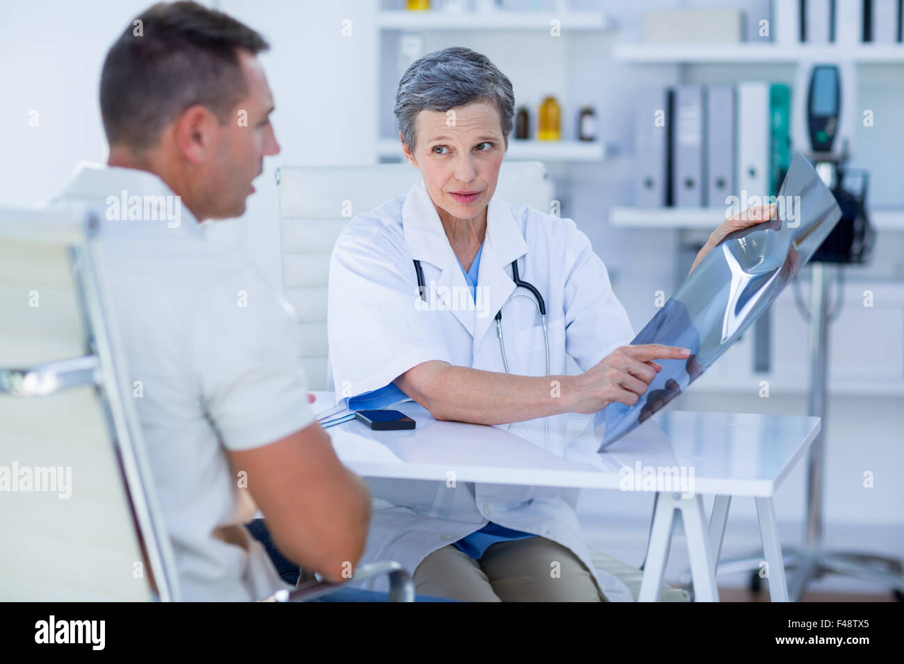 Doctor showing X rays to her patient Stock Photo - Alamy