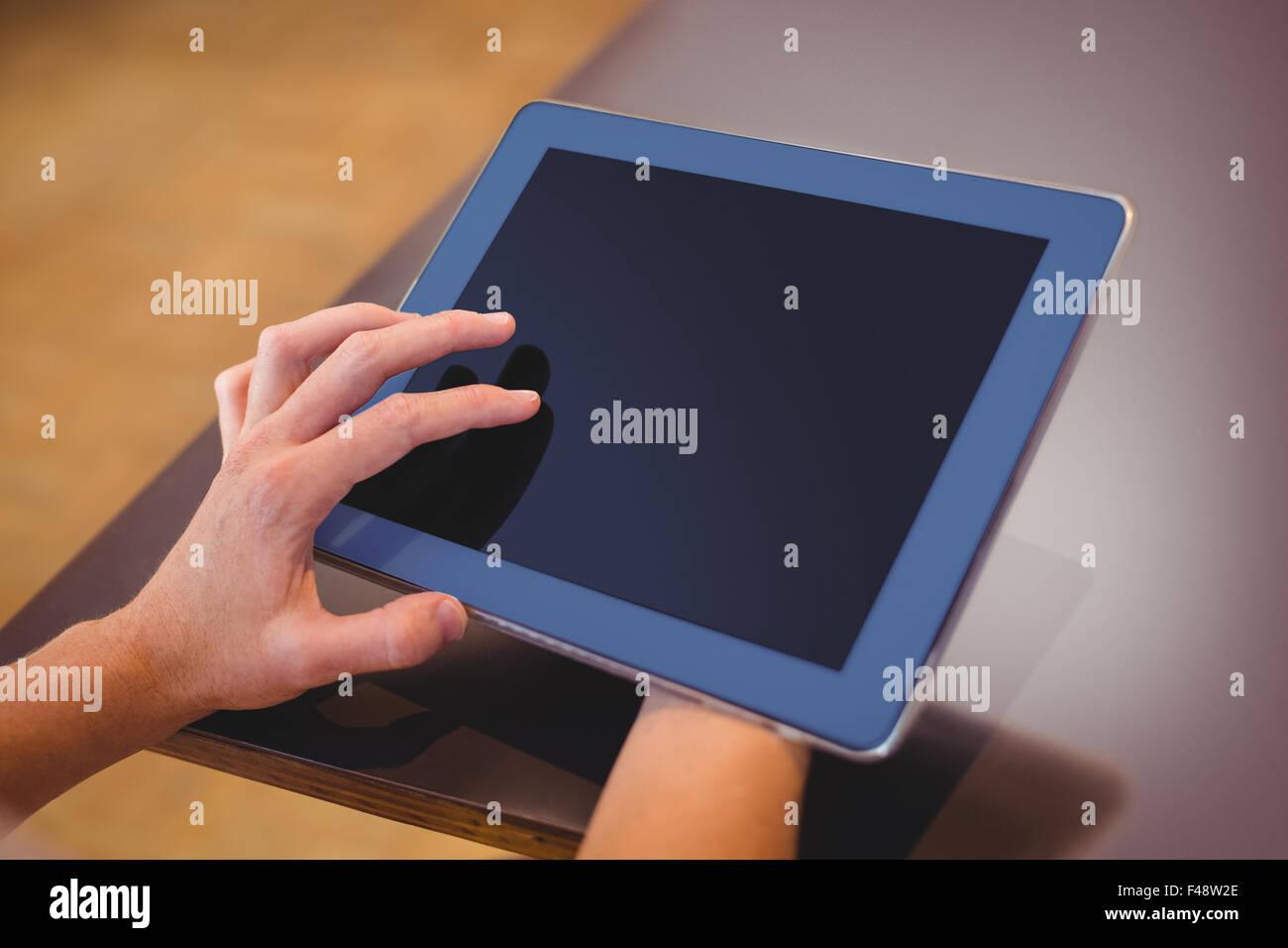 Pretty girl using a small tablet at table Stock Photo - Alamy