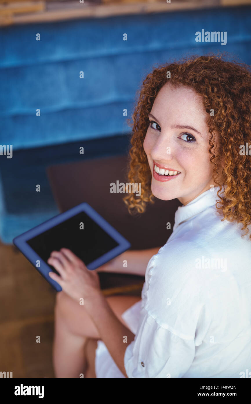 Pretty girl using a small tablet at table Stock Photo - Alamy
