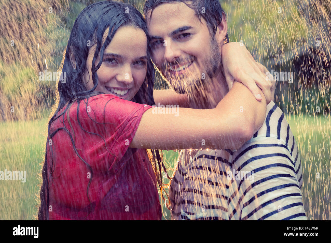 Cute couple hugging under the rain Stock Photo - Alamy