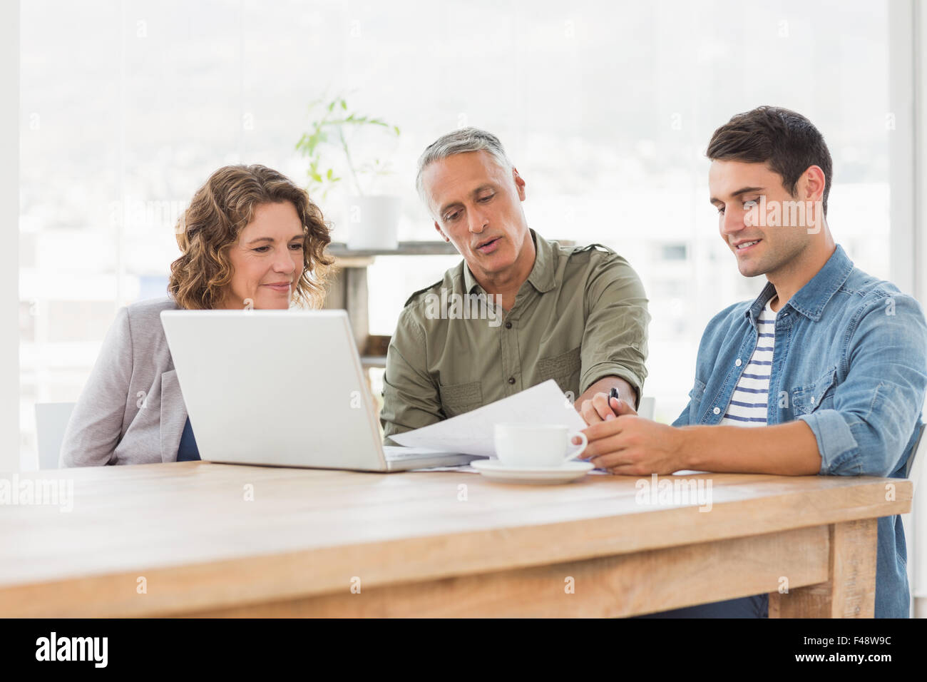 Concentrated team using laptop hi-res stock photography and images - Alamy